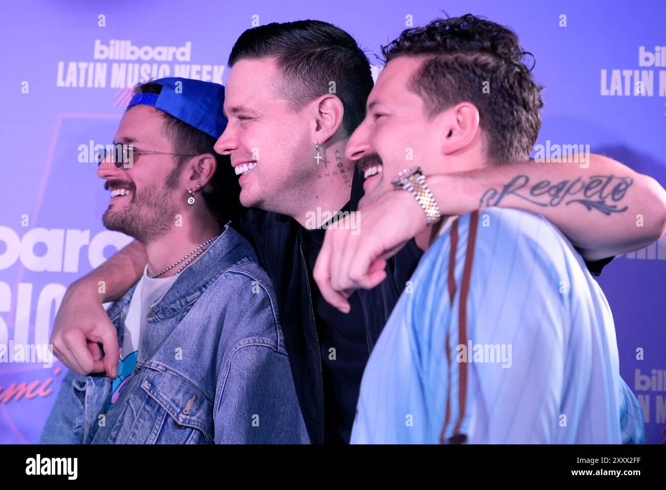 Musicians Mau y Ricky pose with comedian Marko Perez, center, during a ...