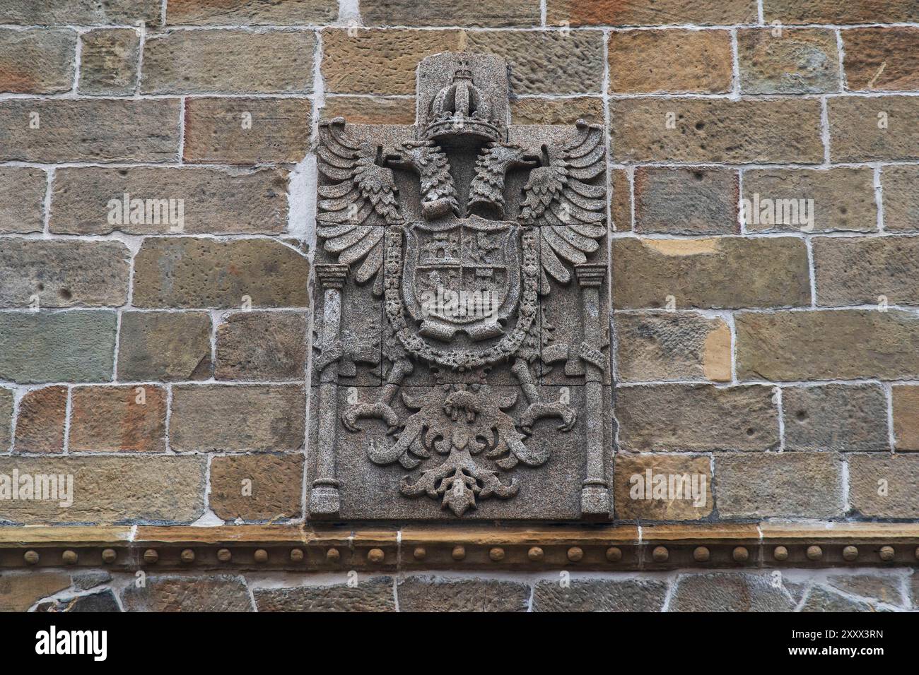 Ancient coat of arms carved in dark grey rock Stock Photo - Alamy