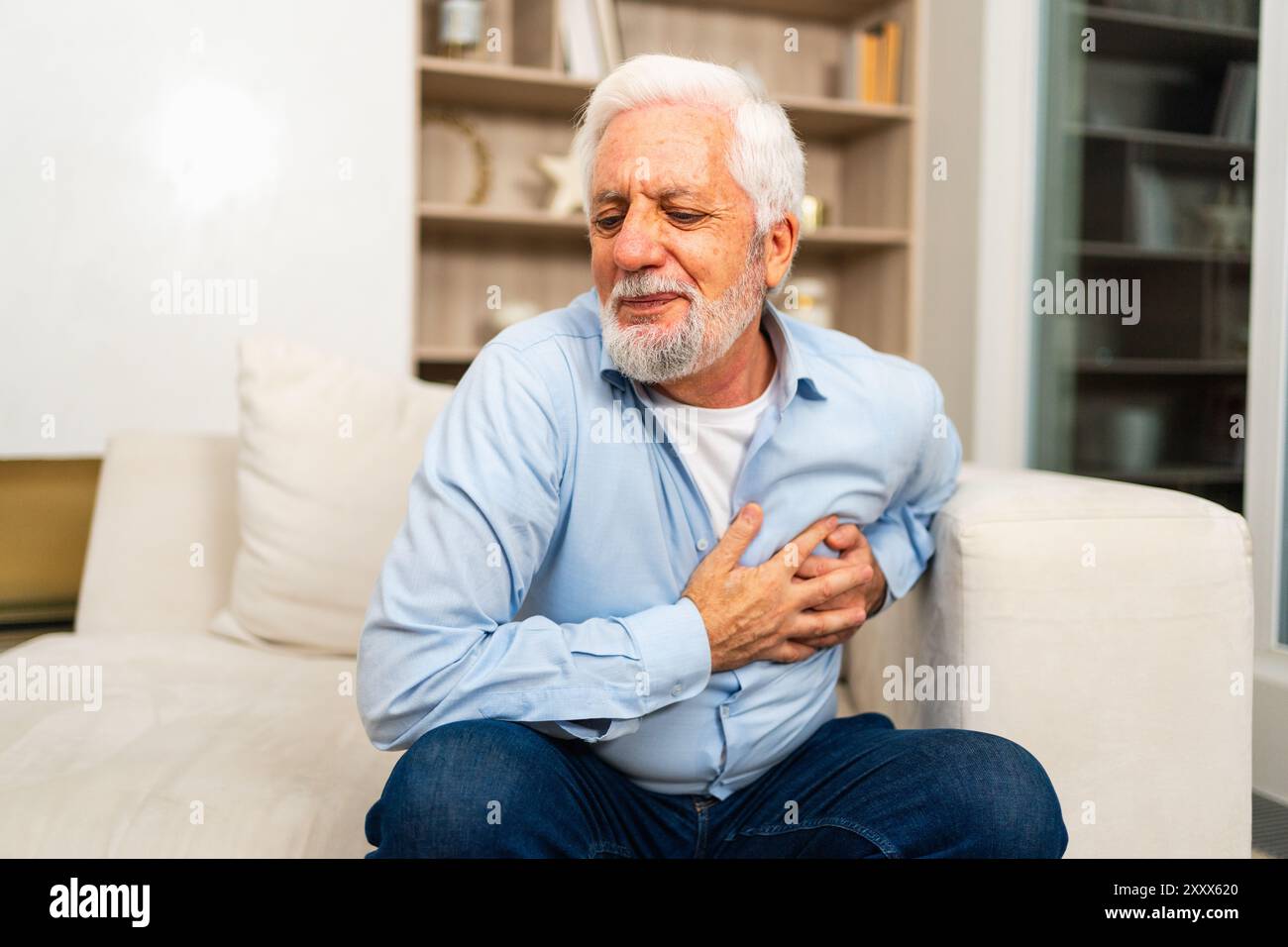 Pain on heart, heart attack. Unhappy middle aged senior man suffering ...