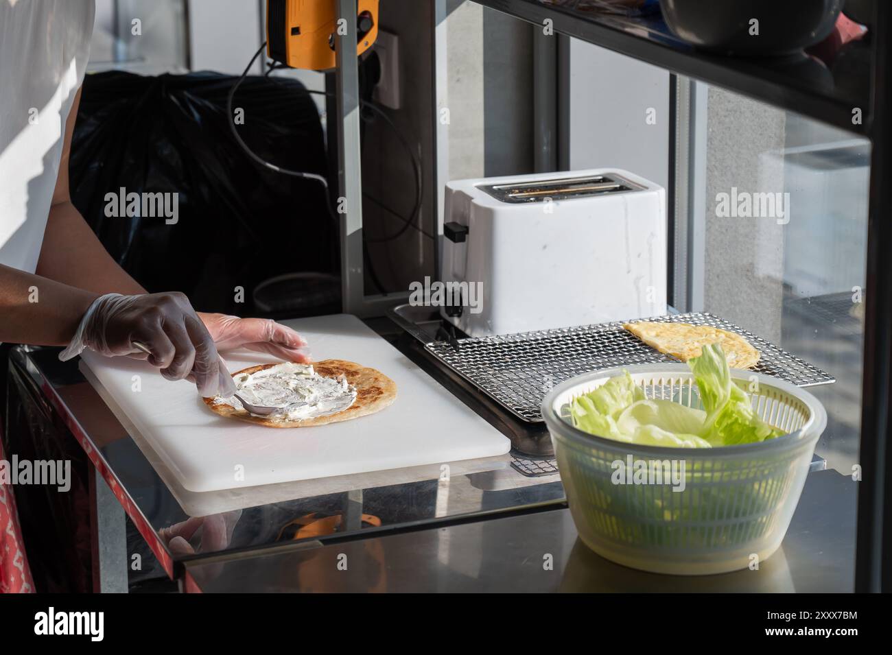 The cook prepares a flatbread with filling. Quesadilla Stock Photo - Alamy