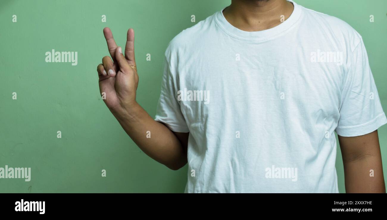 young man's hand being raised while showing letter K using sign ...