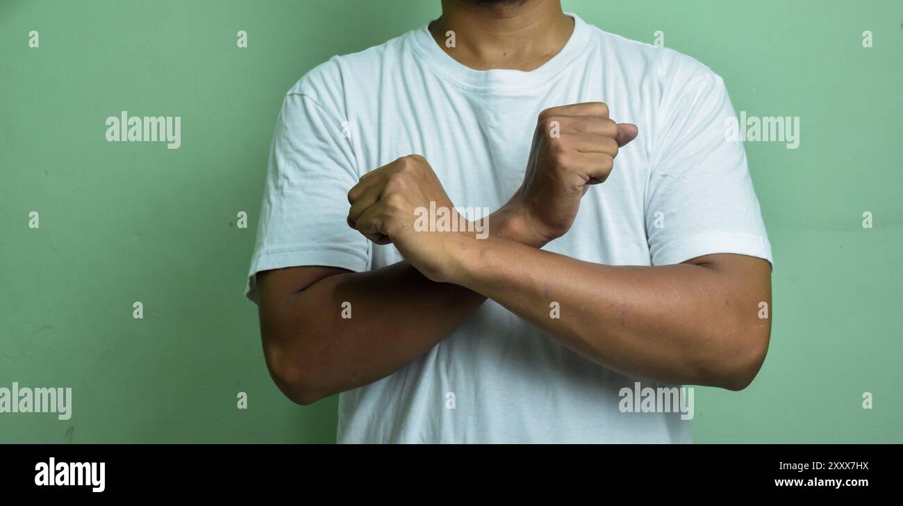 young fair-skinned male keeping hands crossed while expressing his ...