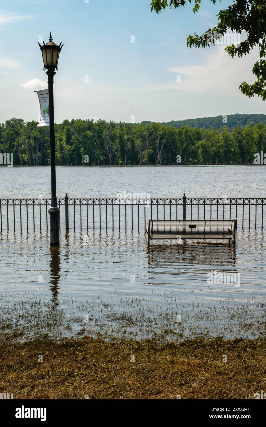 Vertical view of a flooded park with a bench and lamppost Stock Photo ...