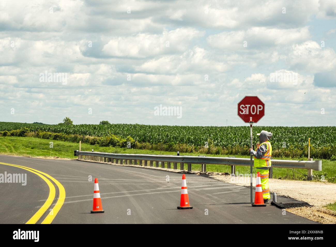 Road worker with stop sign on a rural highway Stock Photo - Alamy