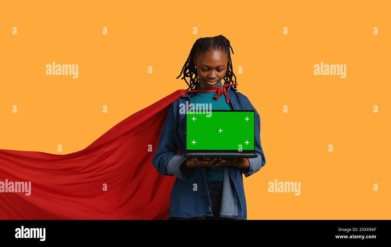 Portrait of BIPOC woman portraying superhero with cape presenting ...