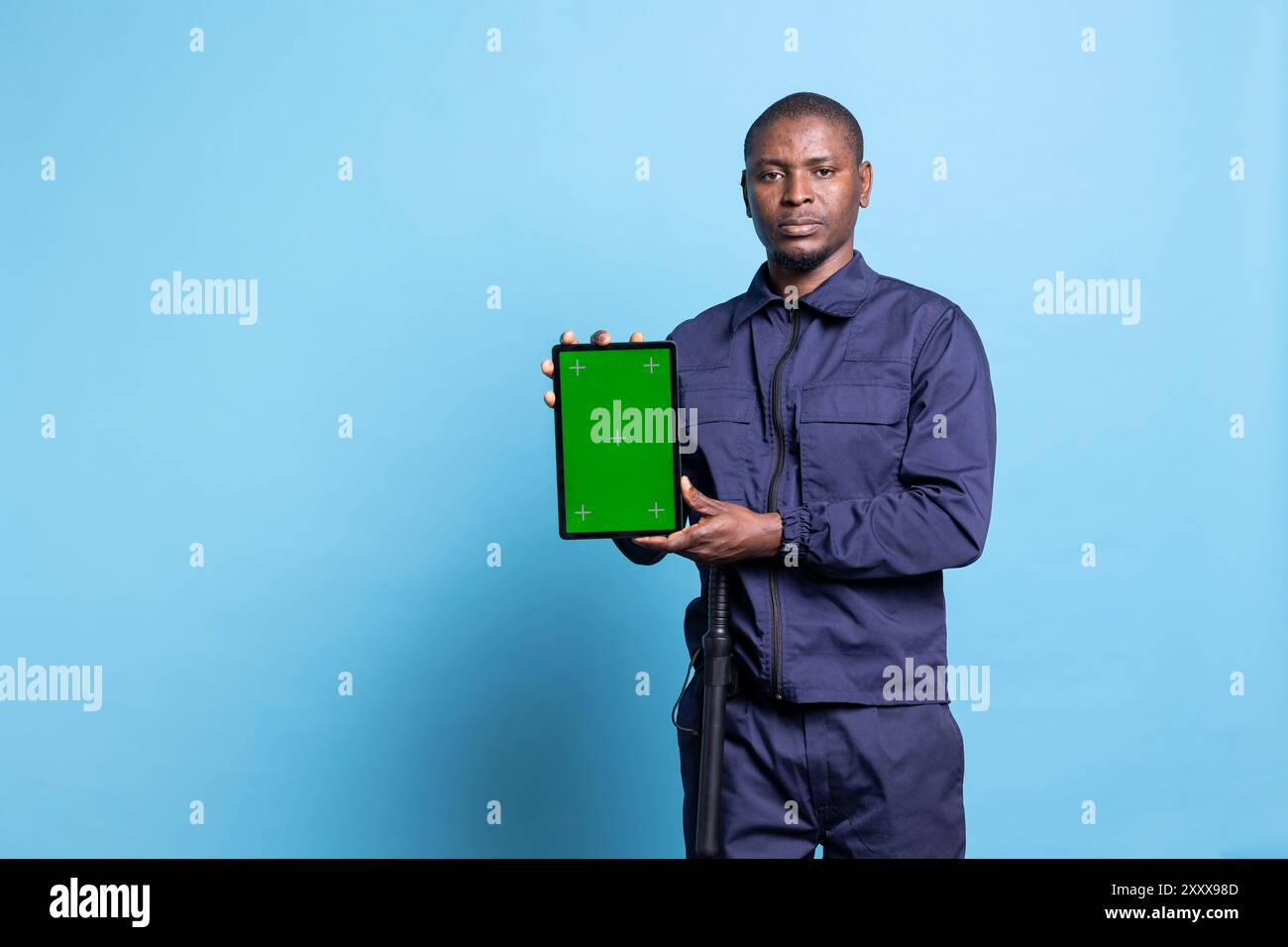 Mall security bodyguard presenting greenscreen on a tablet in studio ...