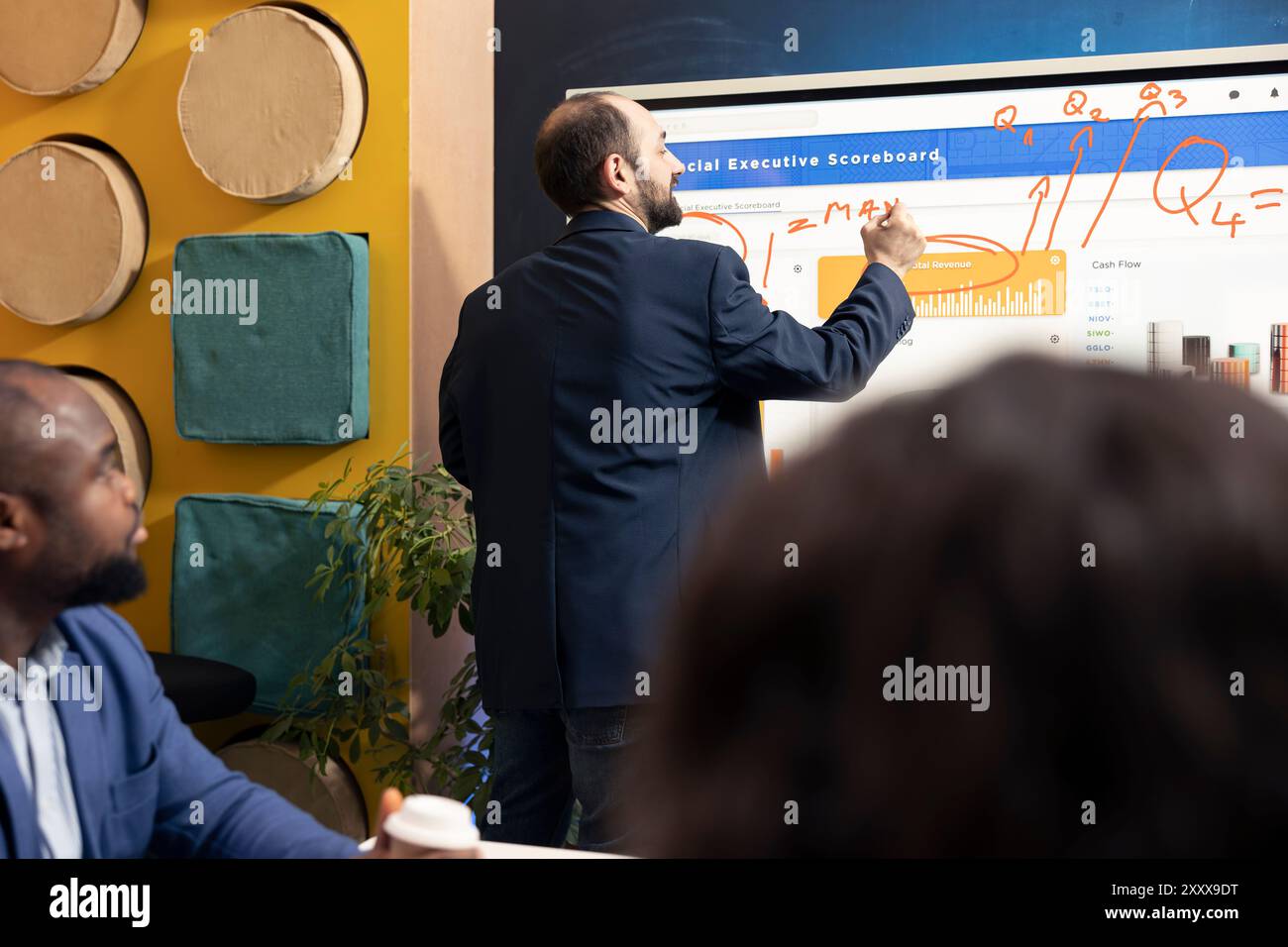 Team of business colleagues examining reports and infographics on ...