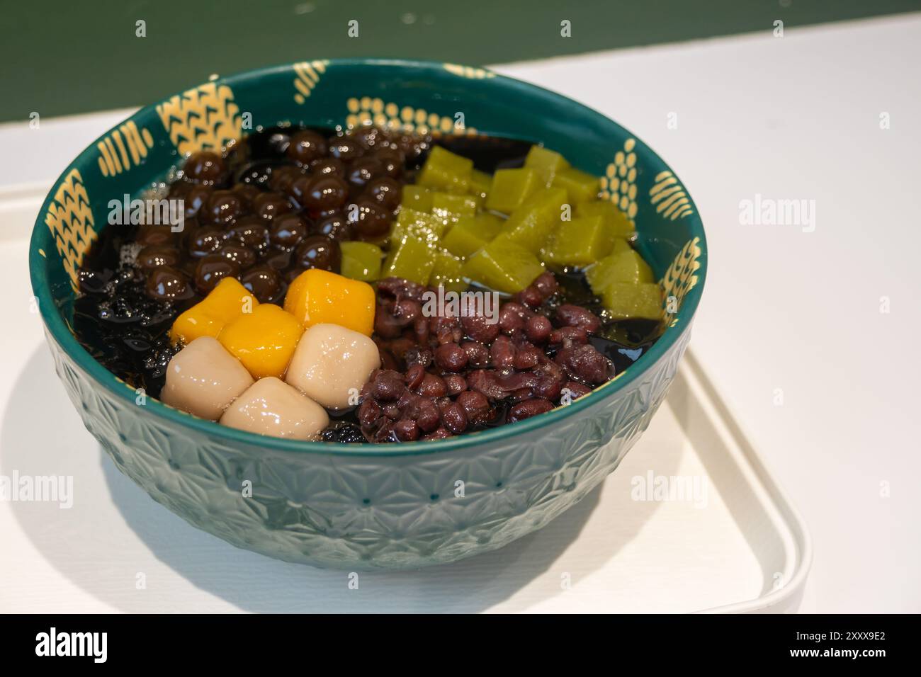 Taiwanese dessert of grass jelly with taro balls, red beans and tea ...