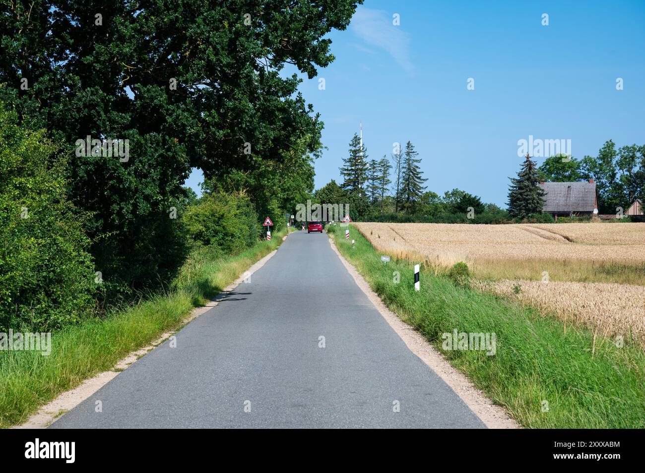 Neukirchen, Holstein, Germany, July 21, 2024 - Asphalt road through the ...