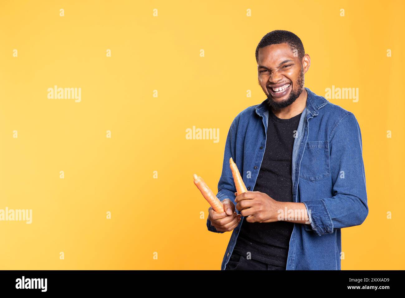 African american energetic guy pretending to play drums with carrots ...
