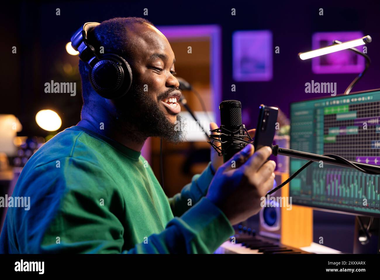 Young songwriter composer recording an acoustic version of his new ...