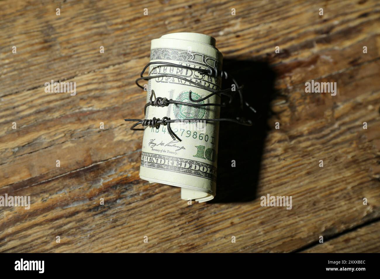 Dollar banknotes with barbed wire on wooden background. Sanctions ...