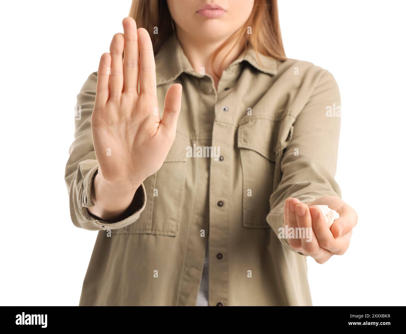 Young female junkie with drugs showing STOP gesture on white background ...