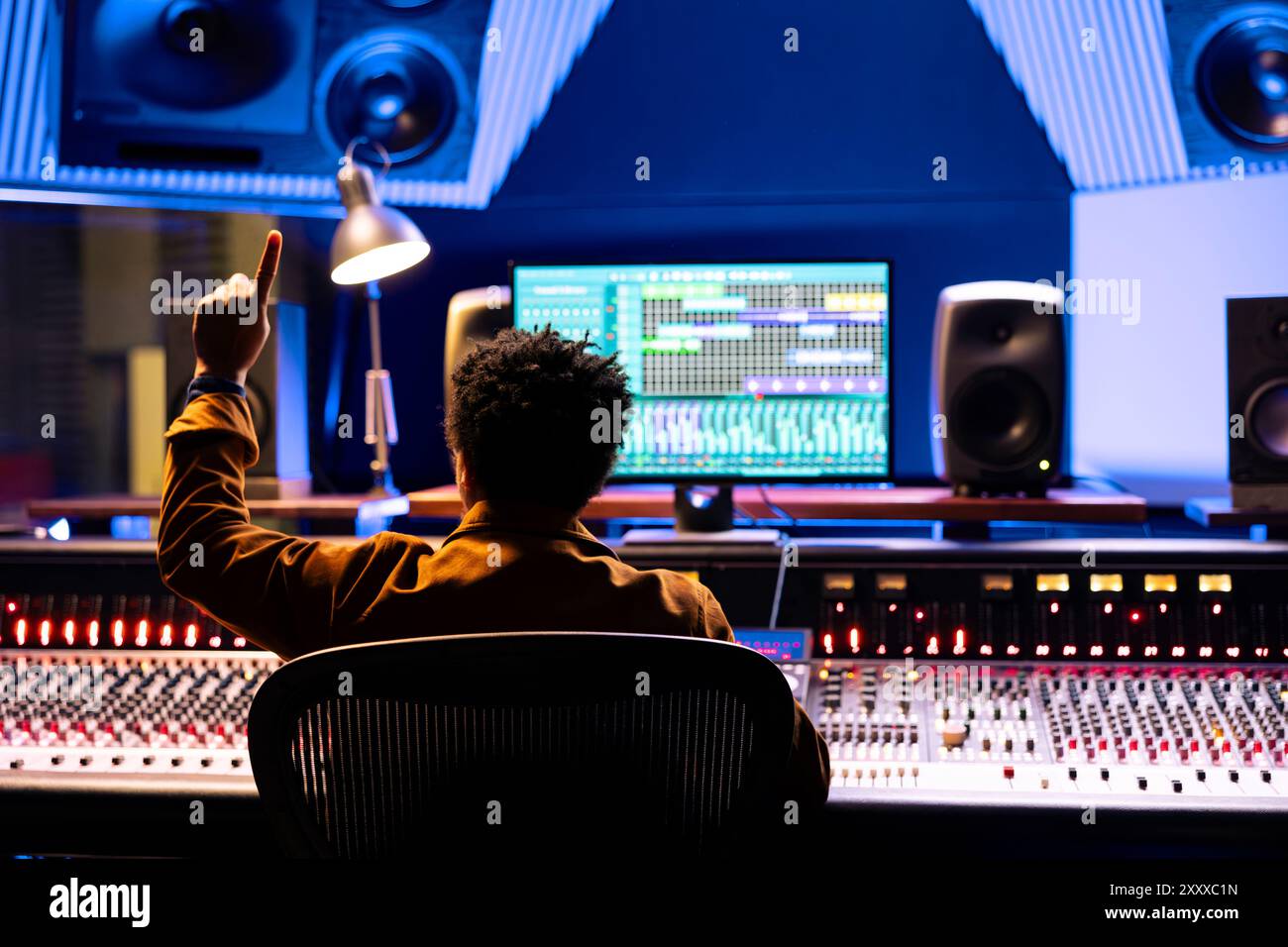 Sound engineer counting down to record singer in sound booth, doing a ...