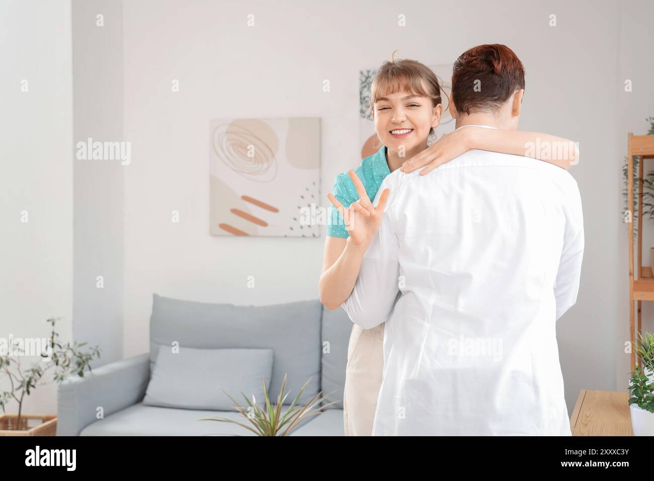 Young deaf mute woman hugging her husband at home Stock Photo - Alamy