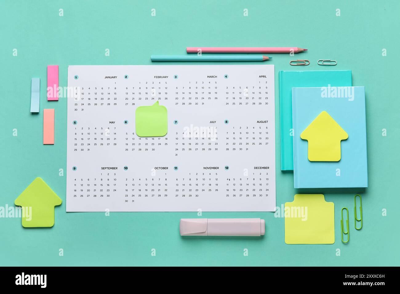 Calendar with office stationery on turquoise background Stock Photo - Alamy