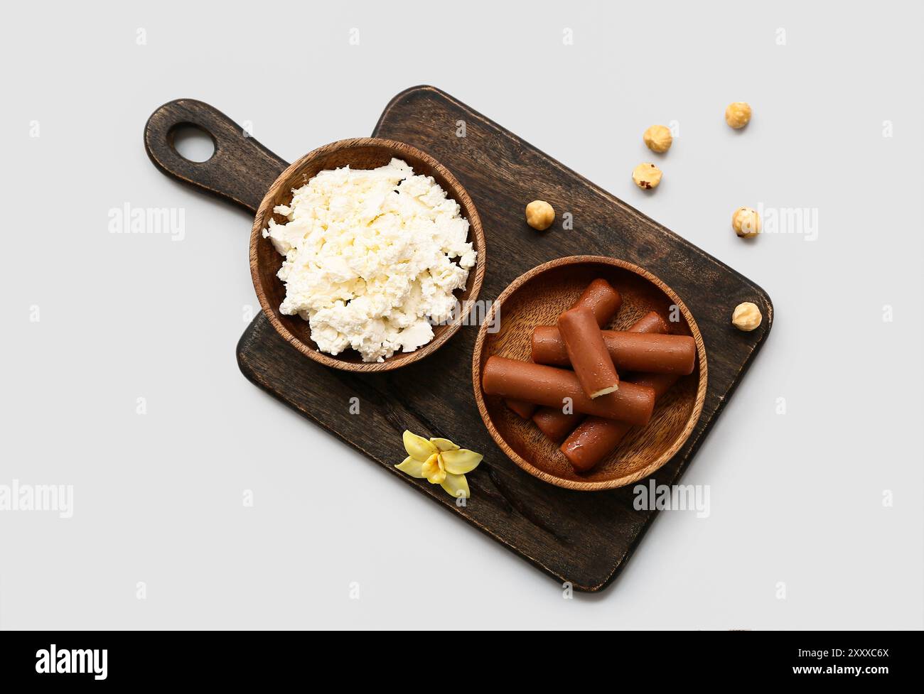 Board with tasty chocolate glazed curd snacks with vanilla flavor and ...