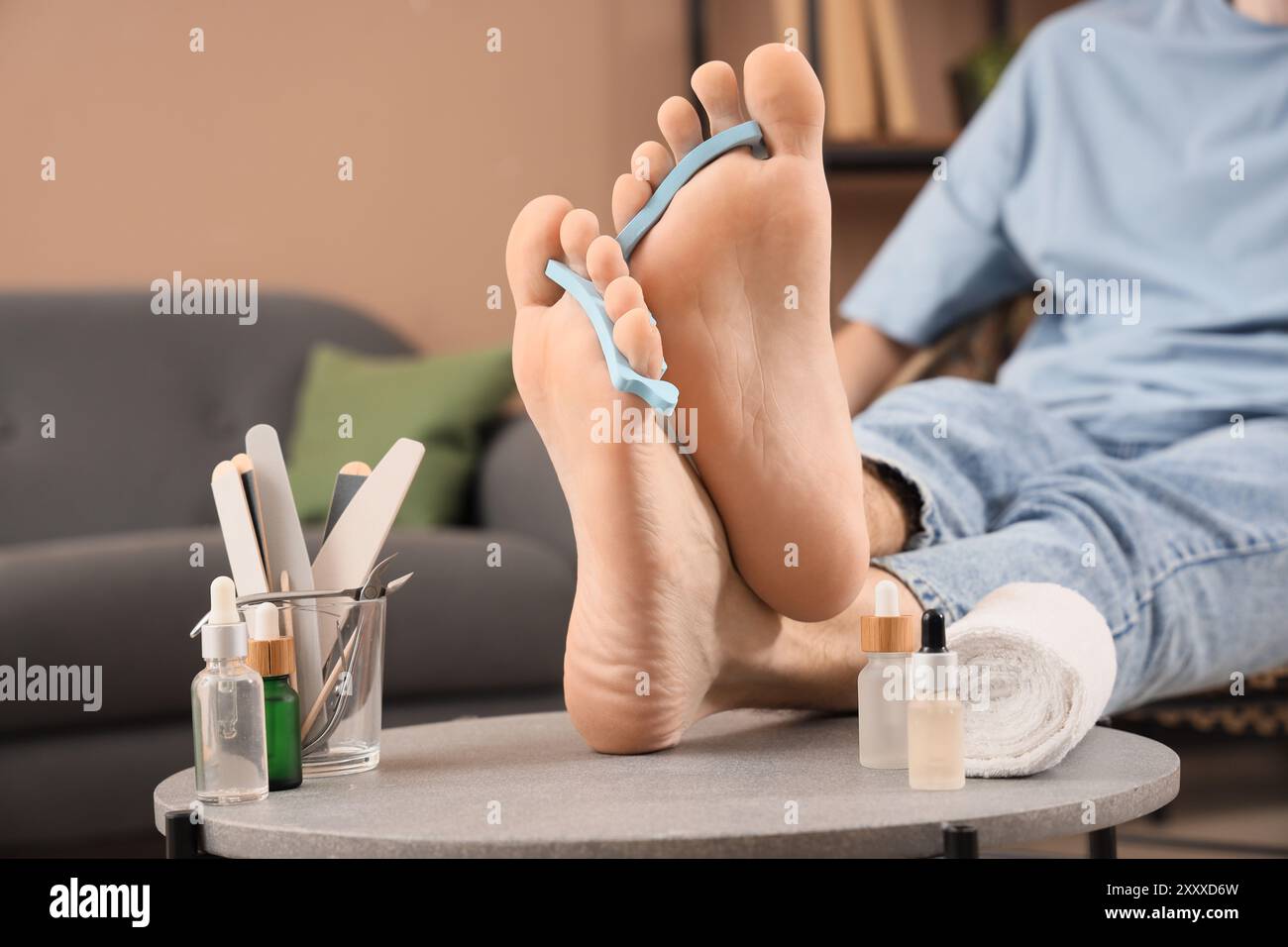 Feet of young man with different tools, toe separator and fresh ...