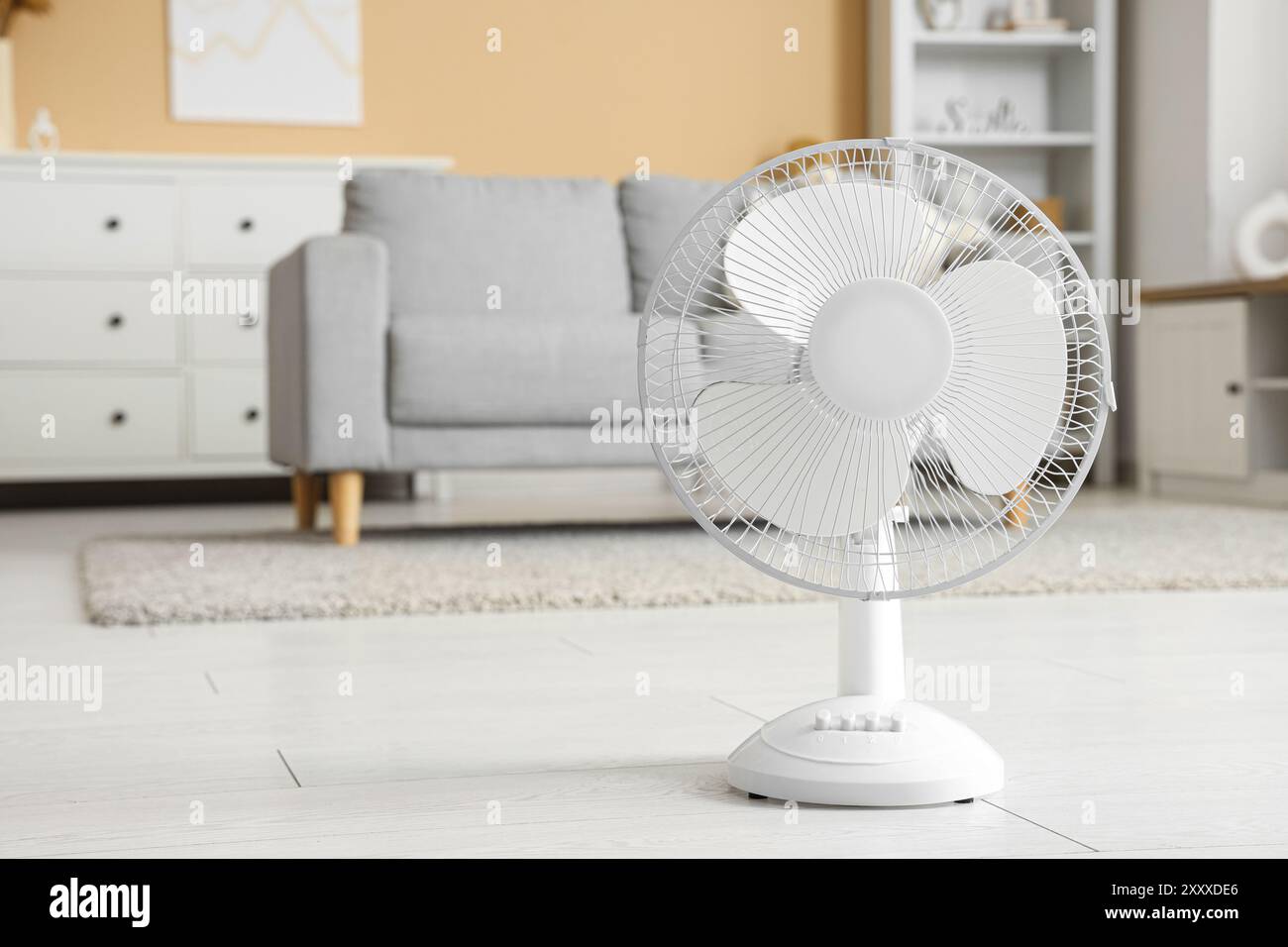 Modern electric fan on floor in interior of living room Stock Photo - Alamy