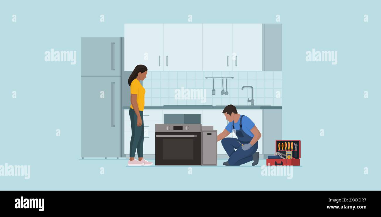 Professional repairman fixing and installing and electric oven in the ...