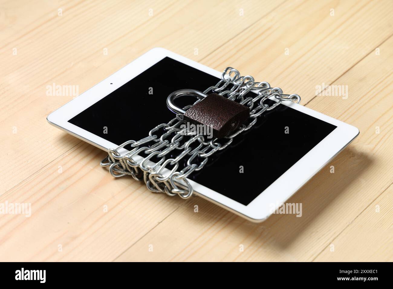 Tablet computer with padlock and chain on wooden background. Cyber ...