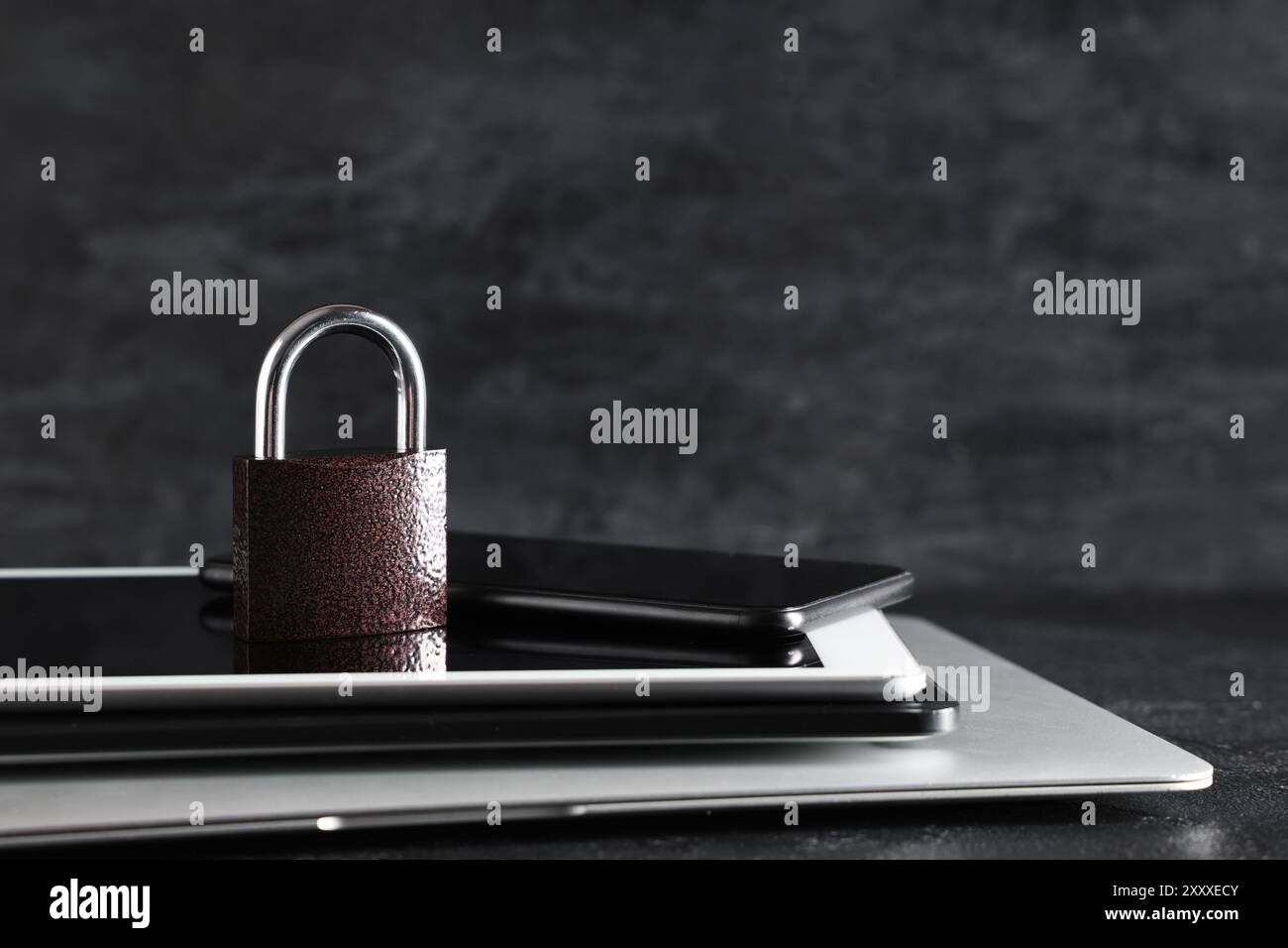 Modern gadgets with padlock on dark background, closeup. Cyber security ...