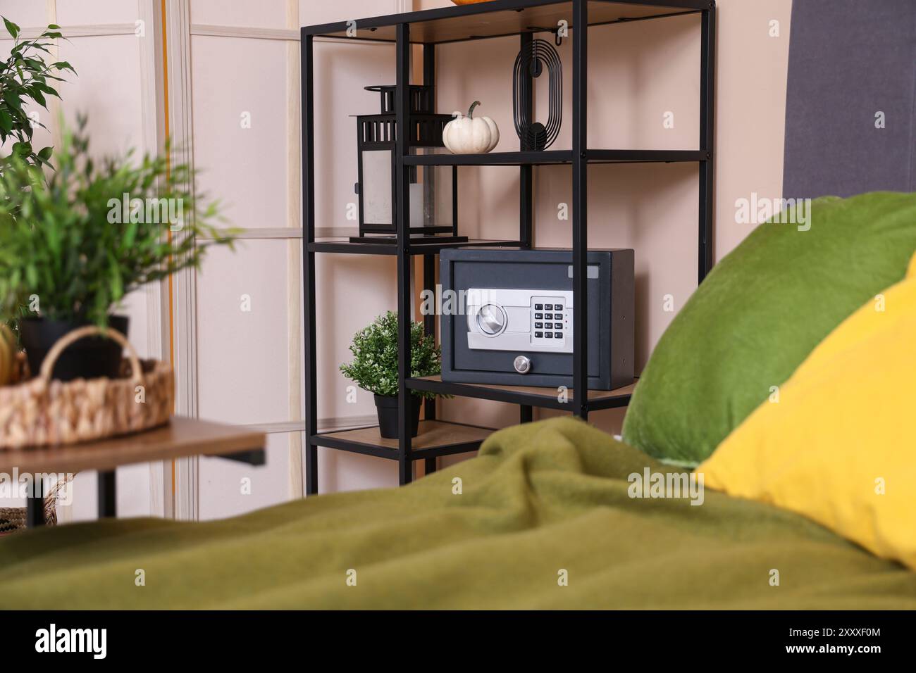 Modern safe on shelf in bedroom interior Stock Photo - Alamy