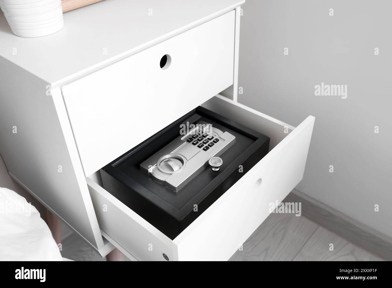 Open drawer with modern safe in bedroom, closeup Stock Photo - Alamy