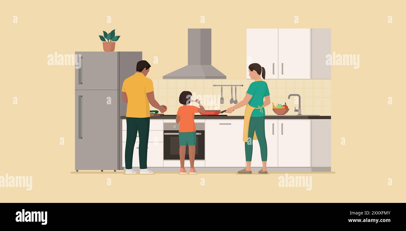 Happy family with child cooking together healthy food in the kitchen ...