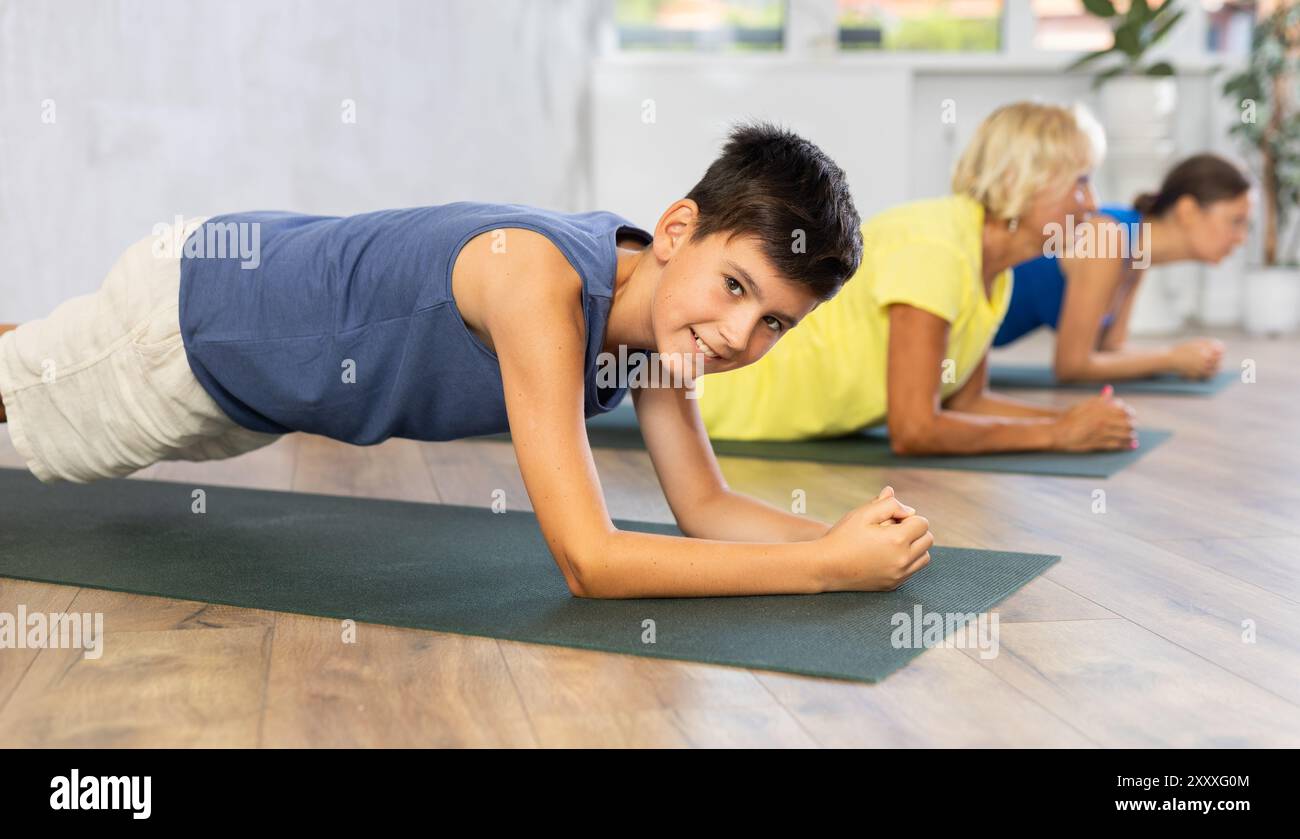 Family in training doing plank exercise to strengthen all abdominal ...