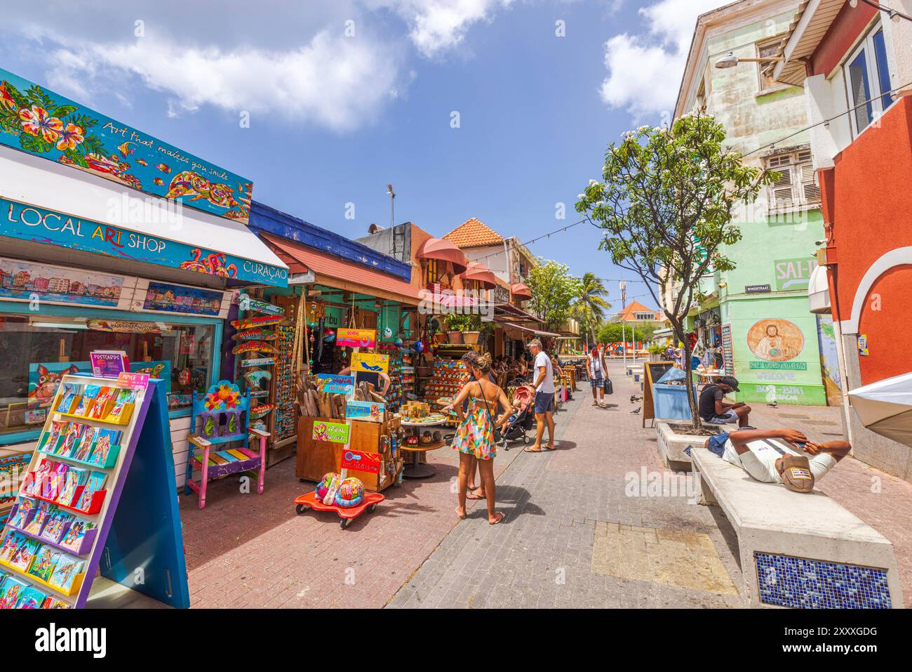 Street market in Curacao with tourists and vibrant souvenir shops with ...