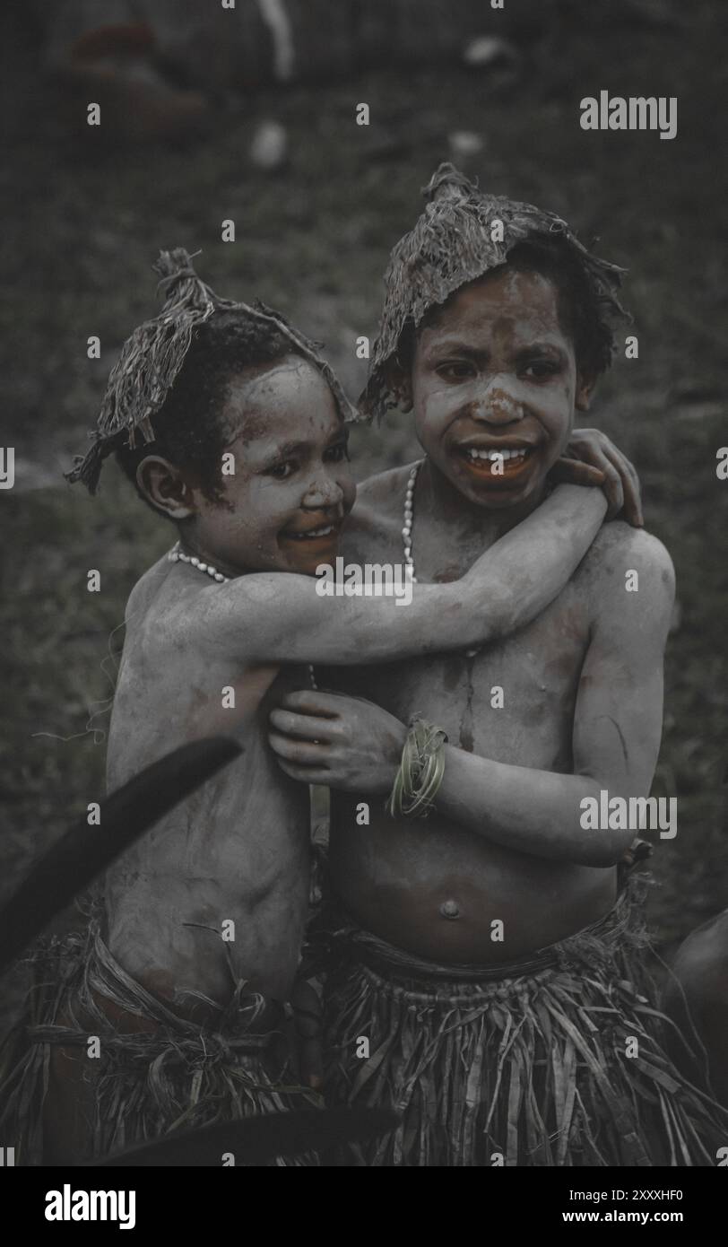 Two girls from Enga Province share a joyful moment, dressed in ...