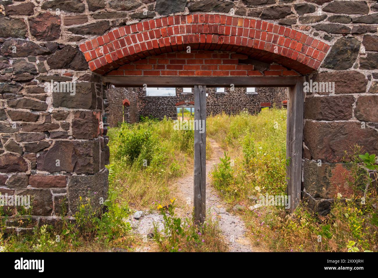A path leading through ruins of an old mine building Stock Photo - Alamy
