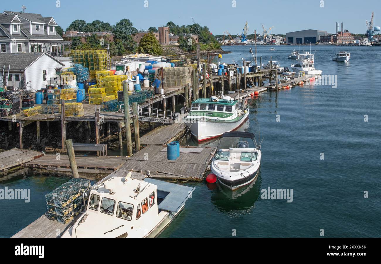 New Hampshire Lobster Dock: Fishing boats dock beside stacks of lobster ...