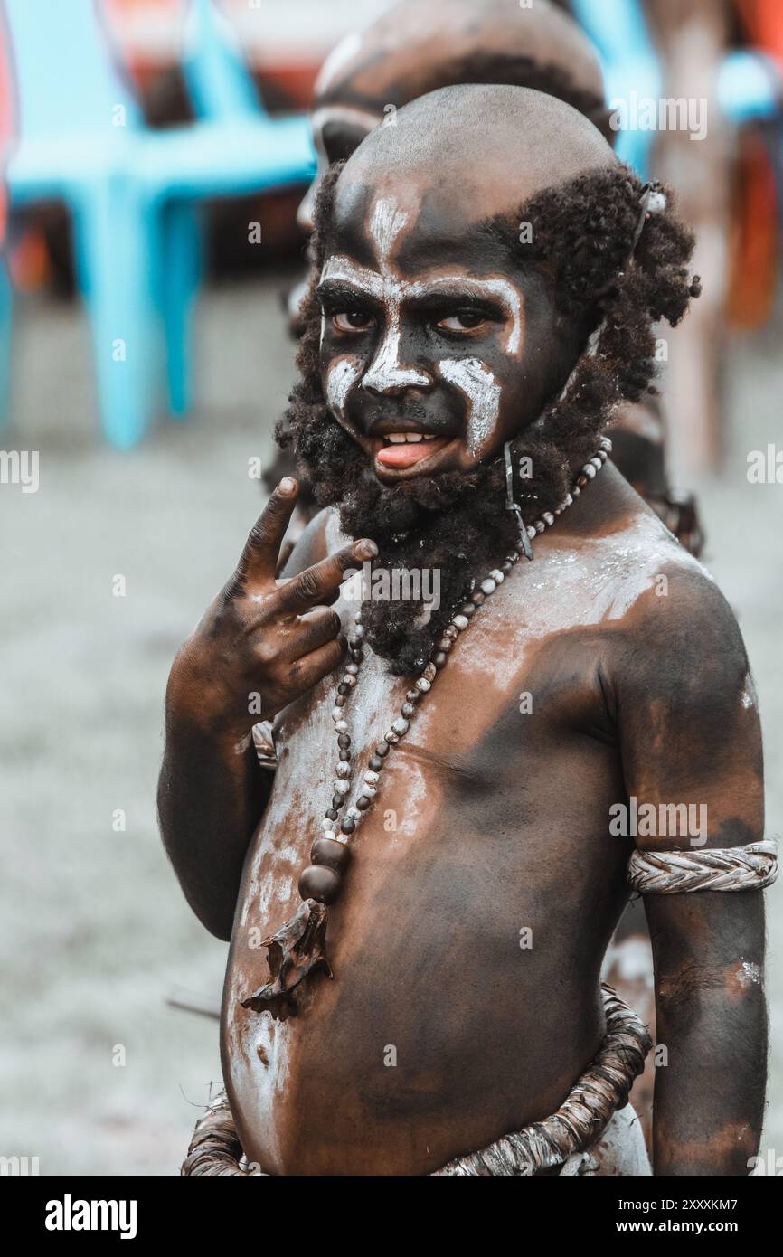 A Papua New Guinean highlander cloaked in ashes and white paint ...