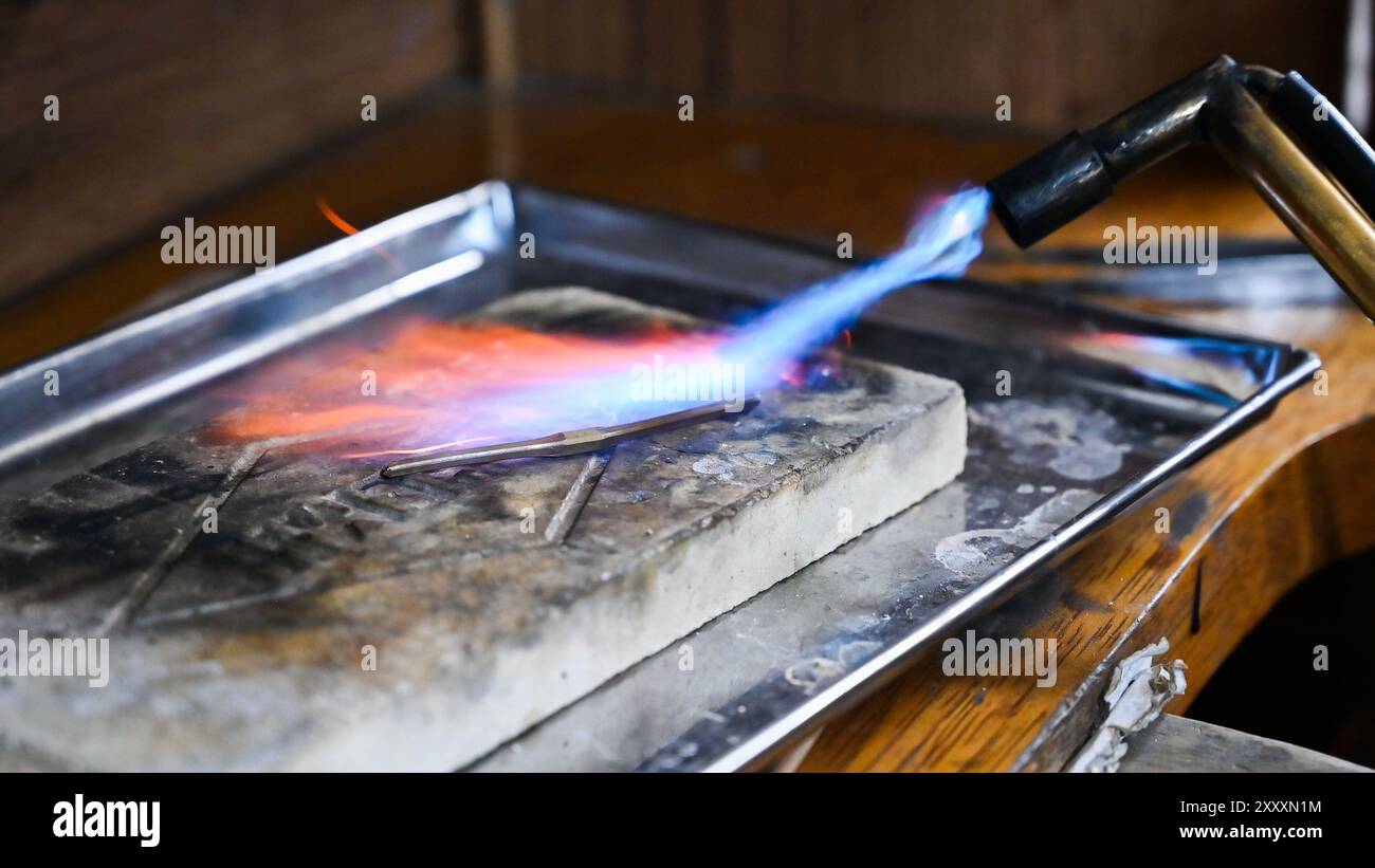 Goldsmith working on a jewel using a blowtorch heating metal Stock ...