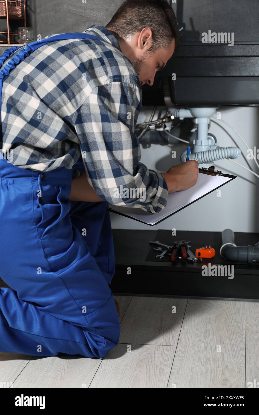 Professional plumber fixing piping system at home Stock Photo - Alamy