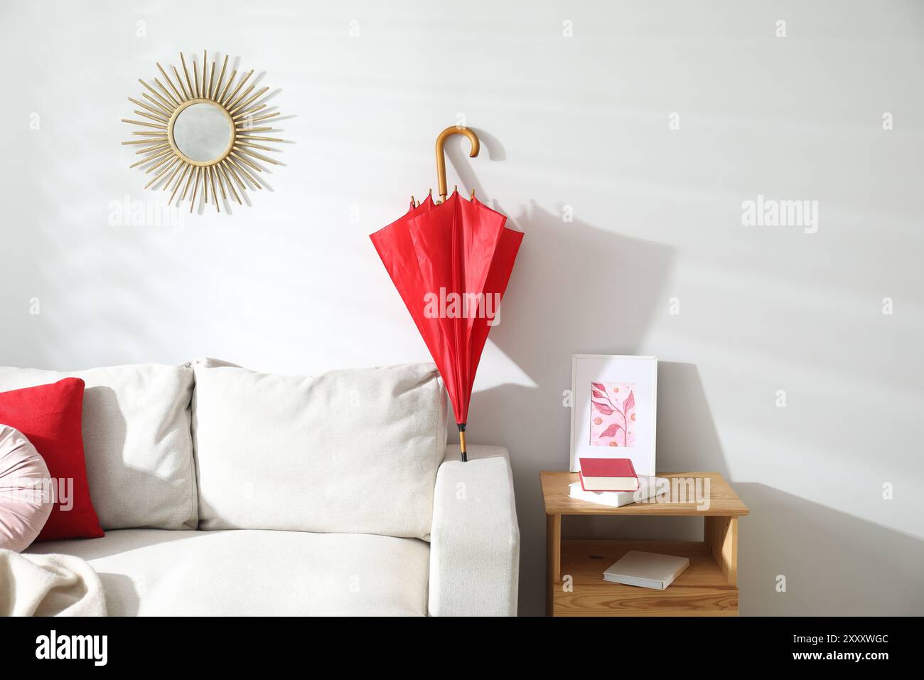 Red umbrella drying on sofa at home Stock Photo - Alamy