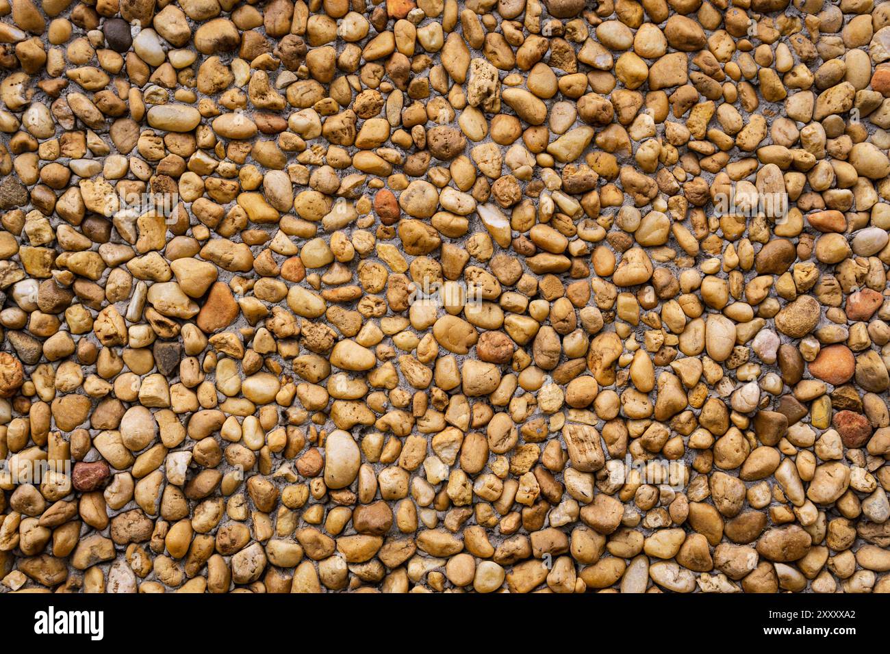 Decorative wall with beige and brown pebbles and stones Stock Photo - Alamy