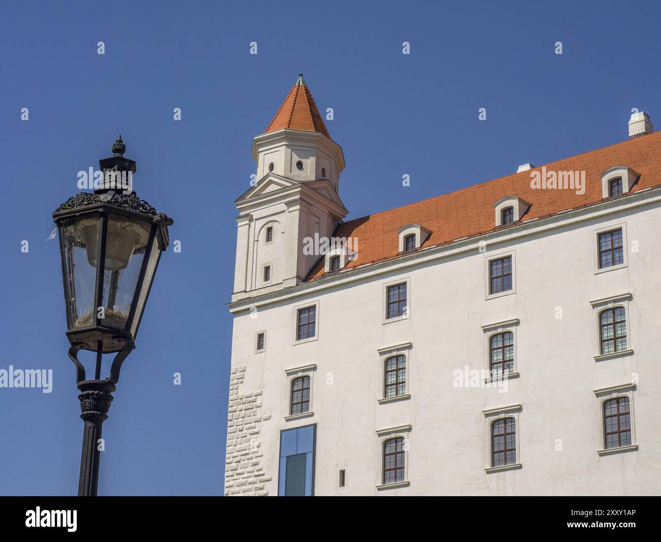 Castle facade with tower and chandelier photographed past, blue sky ...