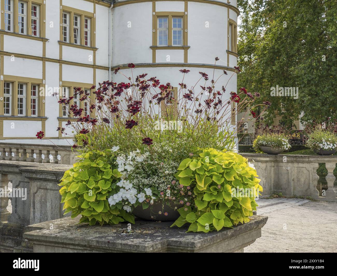 Baroque castle with magnificent floral splendour on the terrace parapet ...