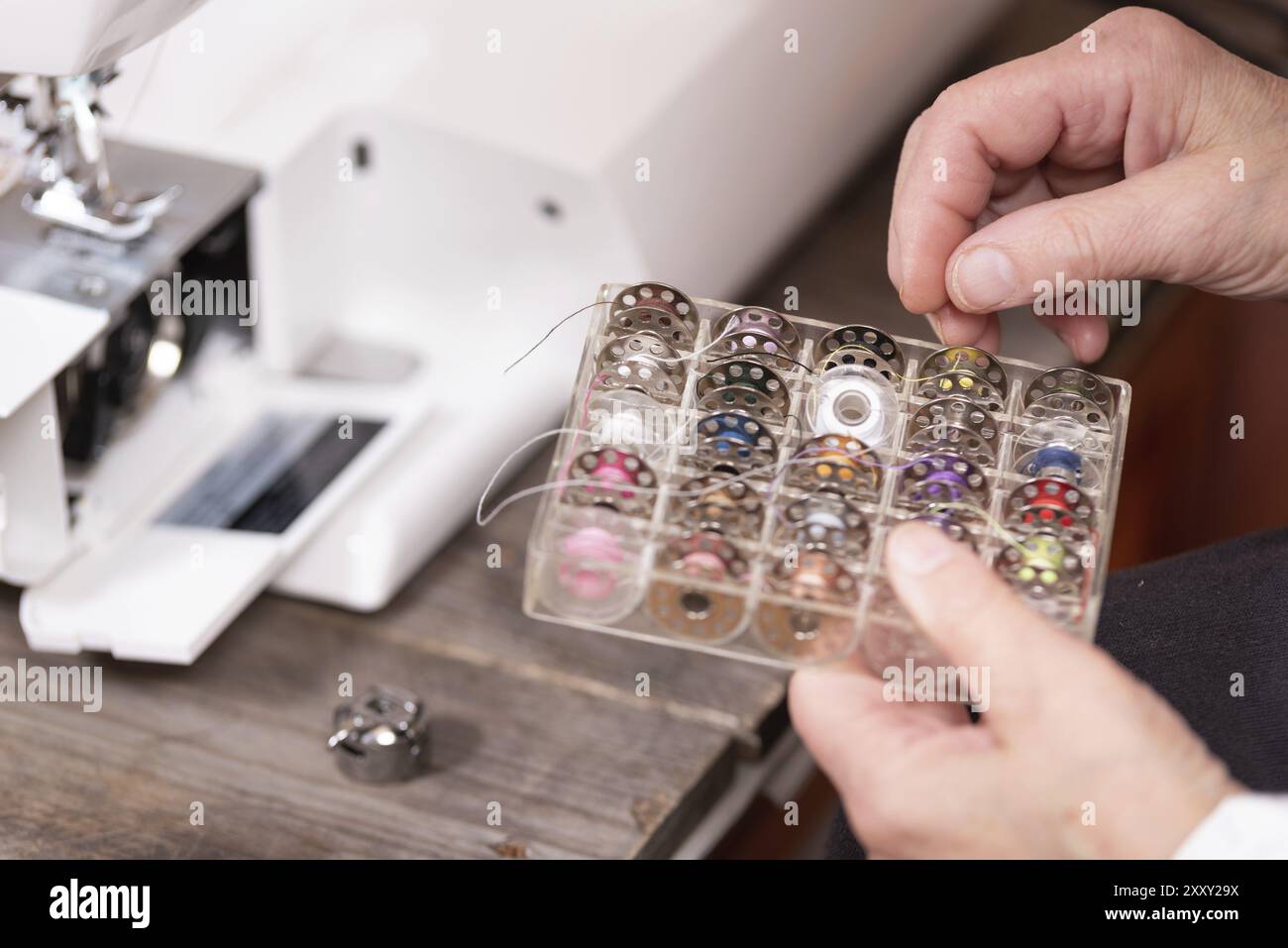 Close up on seamstress hands choosing threads for electrical sewing ...