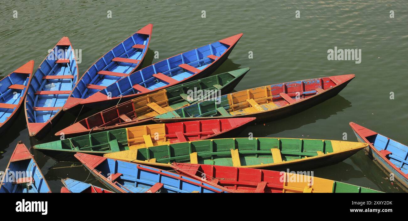 Bright colored timber rowing boats in Nepal Stock Photo - Alamy