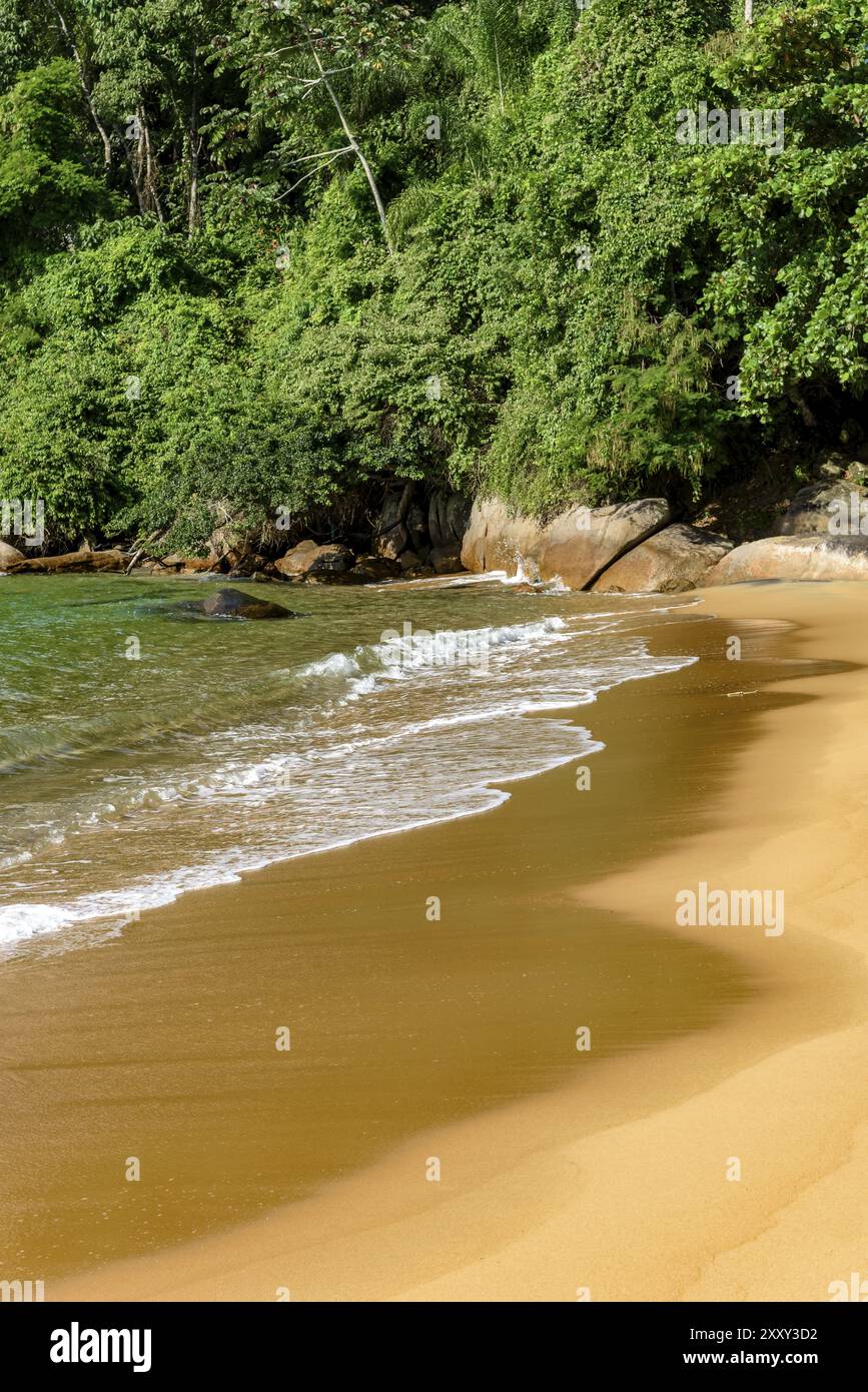Deserted and unspoilt beach with its limpid and transparent waters that ...