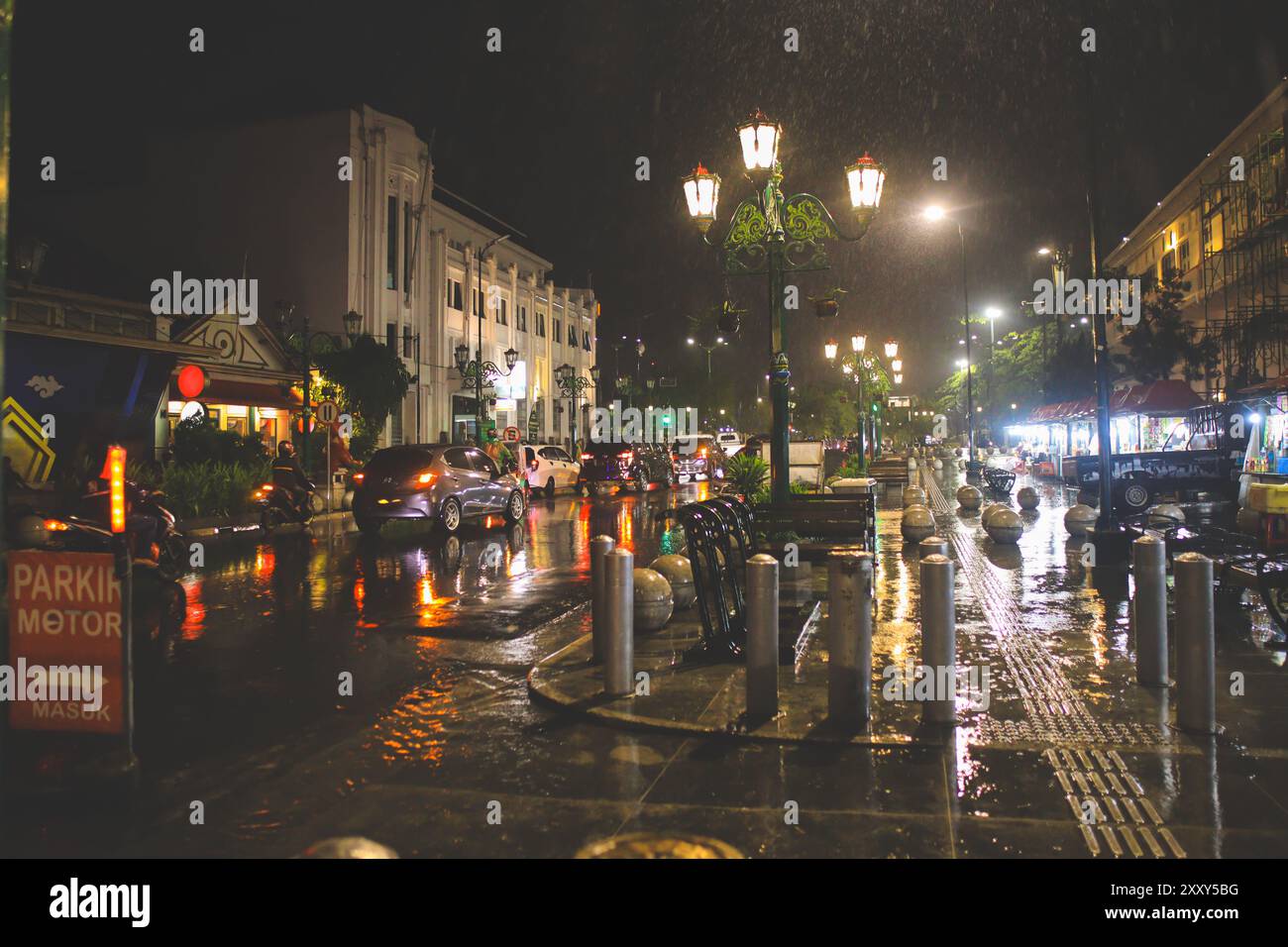 Rain in the city. Rain at night in the middle of town. Busy hour in ...