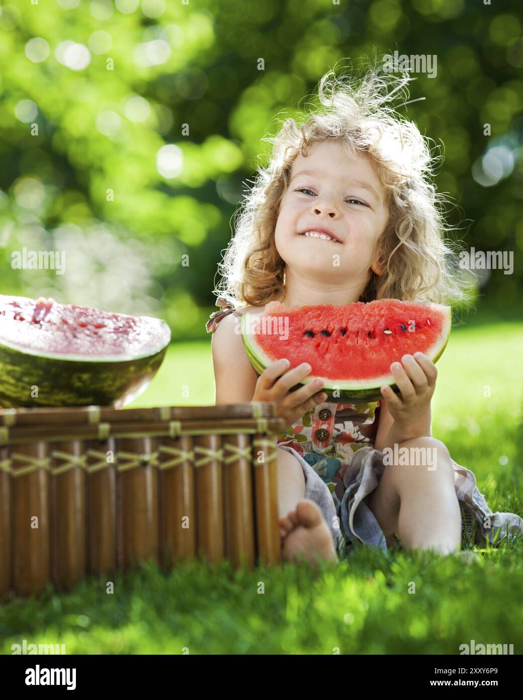 Happy smiling child eating watermelon outdoors in spring park Stock ...