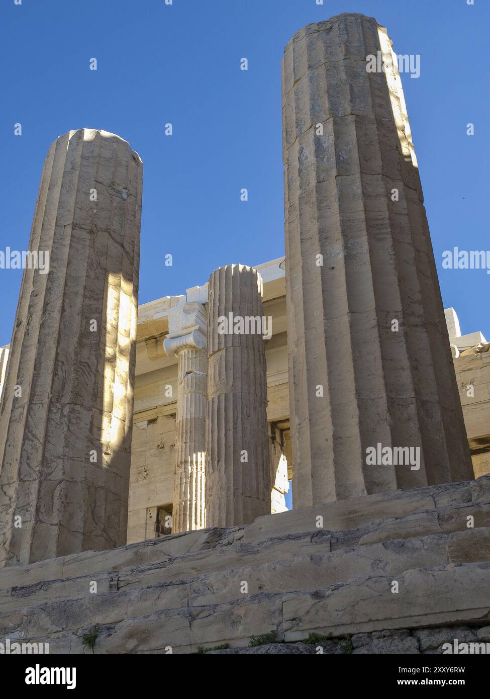 Large ancient columns and stone structures against the blue sky, athens, greece Stock Photo - Alamy