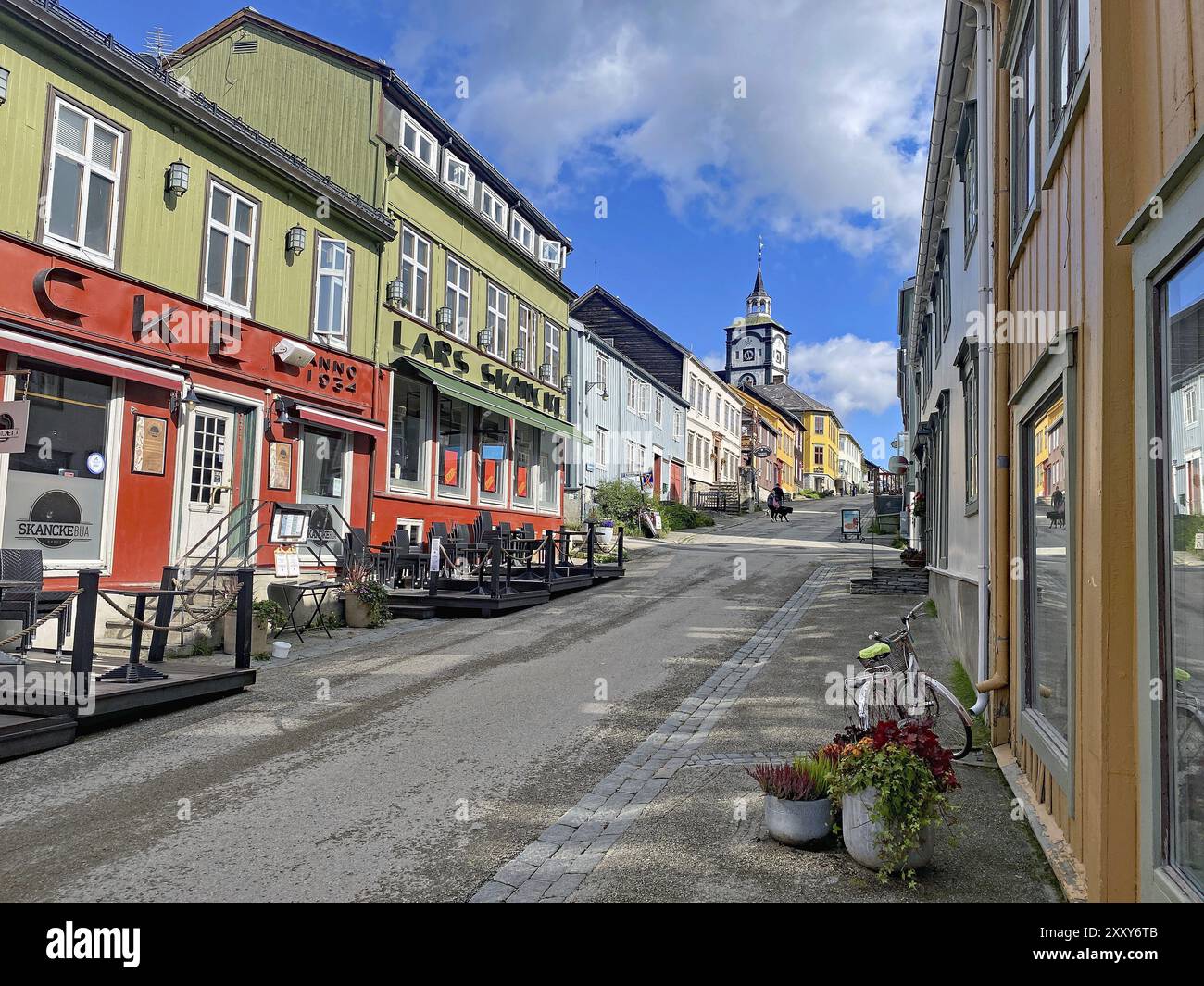 A city street with colourful houses and a church tower in the ...