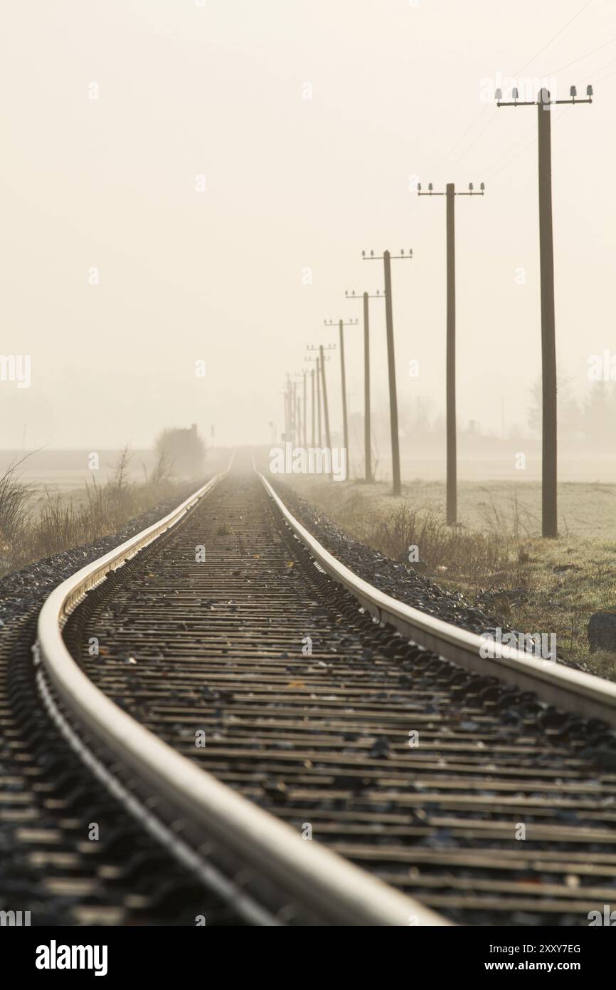 Single-track railway line in the morning fog Stock Photo - Alamy