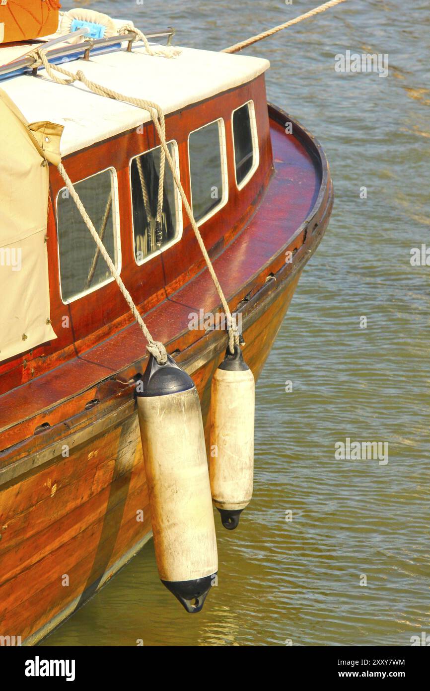 Side view of a wooden vintage boat in the harbor Stock Photo - Alamy